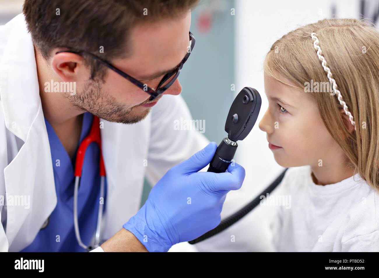 Picture of child optometry male optometrist optician doctor examines ...