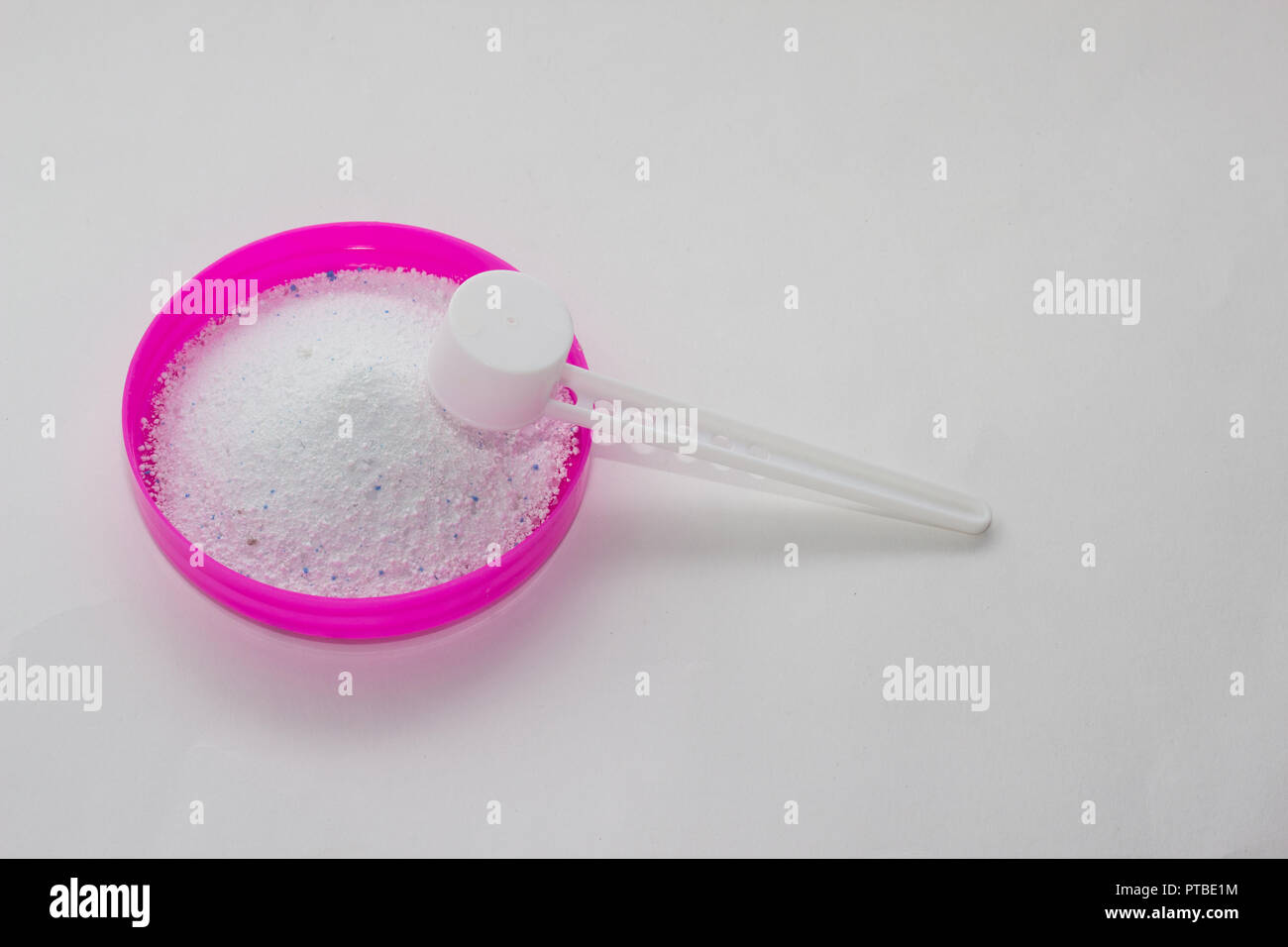 Stain remover and bleach on a red cover with a measuring spoon on a ...