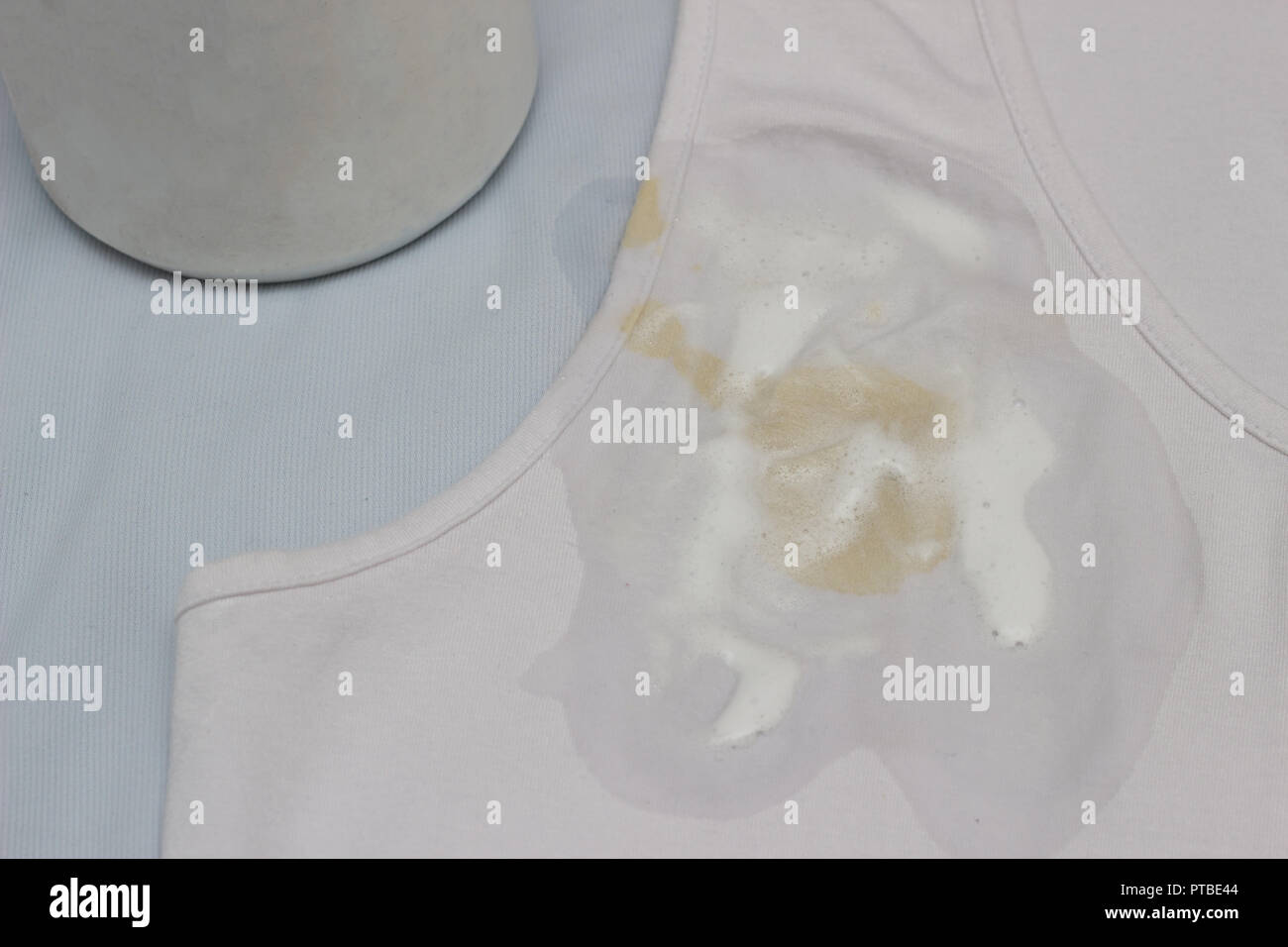 Spot on a white T-shirt filled with stain remover, fighting stains on ...