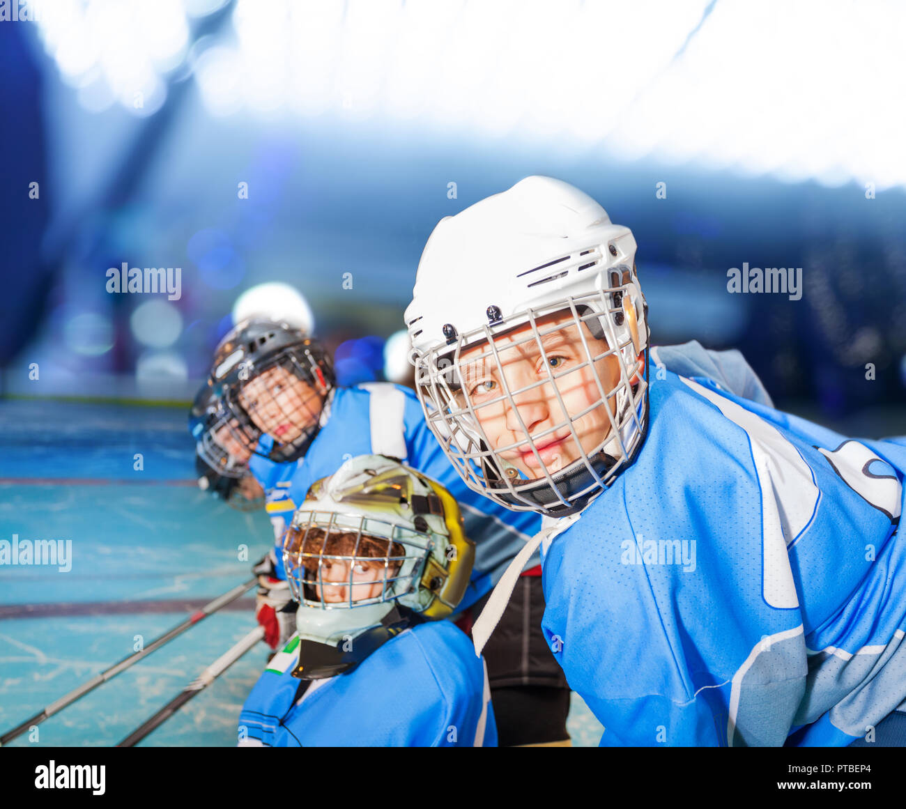 Close-up portrait of happy boy in hockey uniform during the math on ice ...