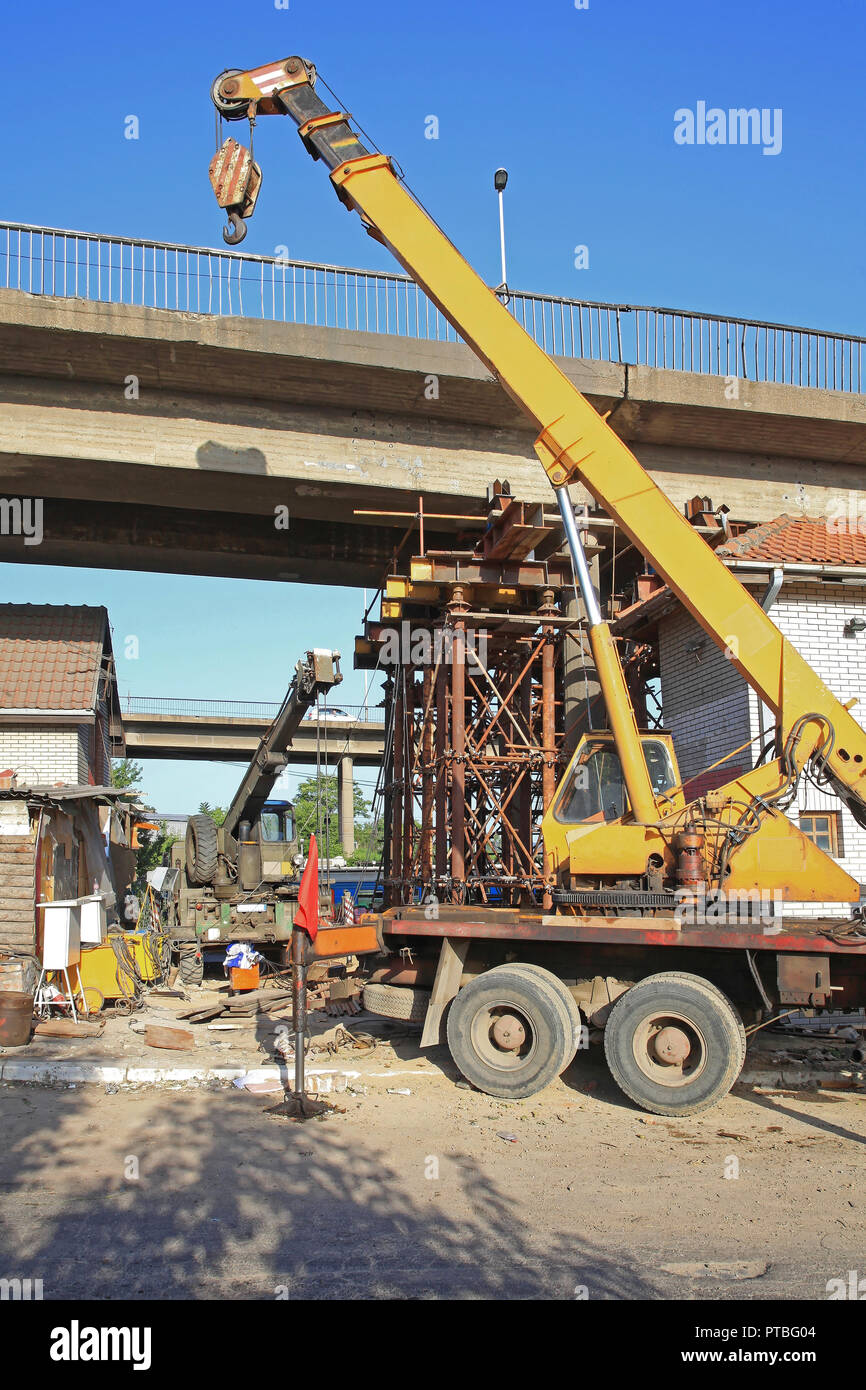 Crane and scaffolding support at damaged bridge construction site ...