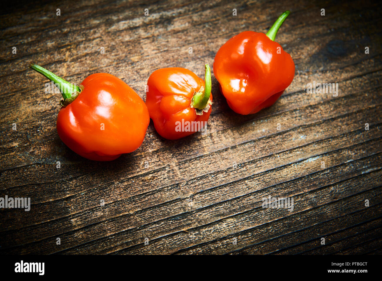 Group of Red fresh chilli on old rustic wood desk. Food background ...