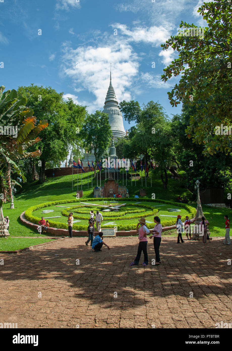 White stupa and large ornamental garden clock in the grounds of wat ...
