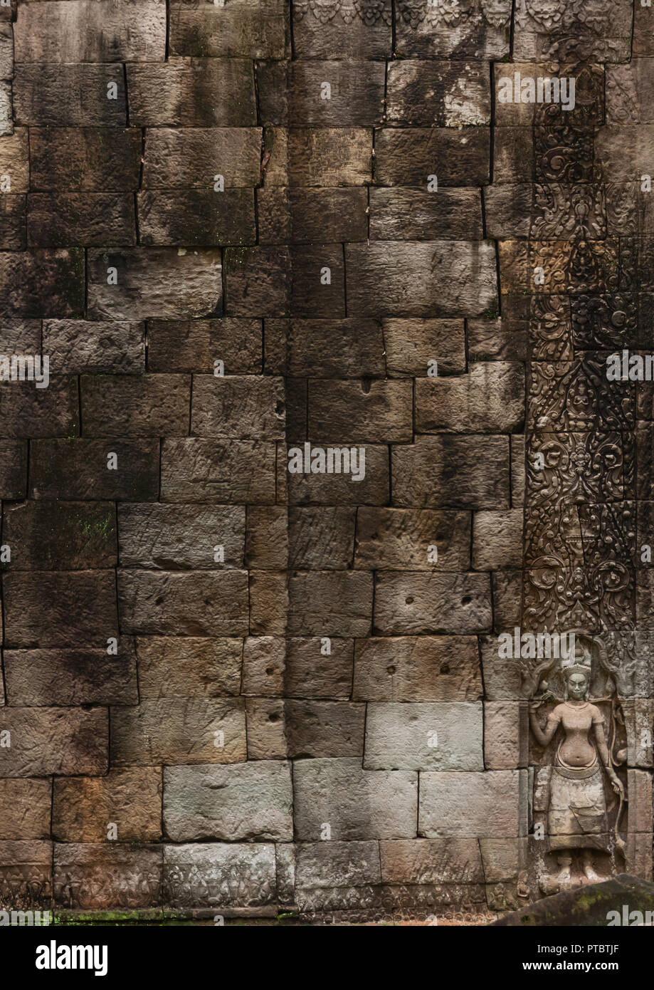 Khmer statue at the bottom of a temple wall in Angkor wat, Siem Reap ...