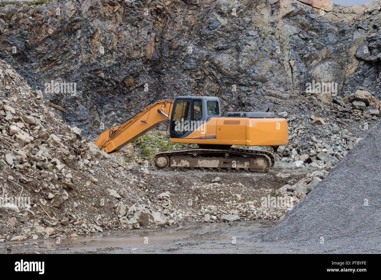 A large construction excavator of yellow color on the construction site ...