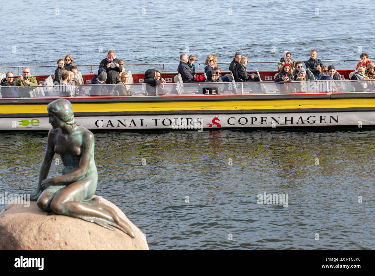 The Little Mermaid in front of Canal Tours Copenhagen boat in the Harbour of Copenhagen, Denmark ...