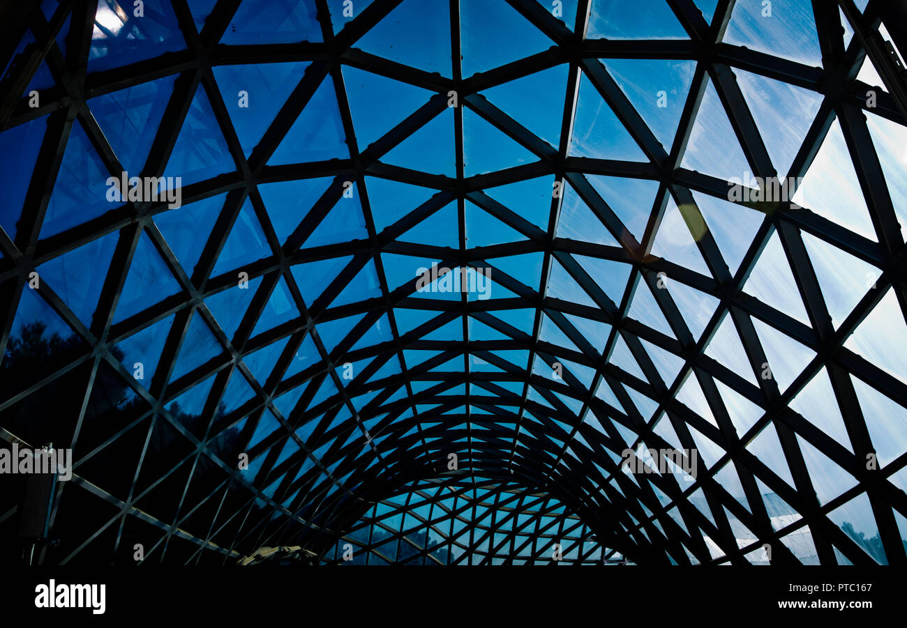 glass roof of a modern building and blue sky . Triangle aluminum alloy ...