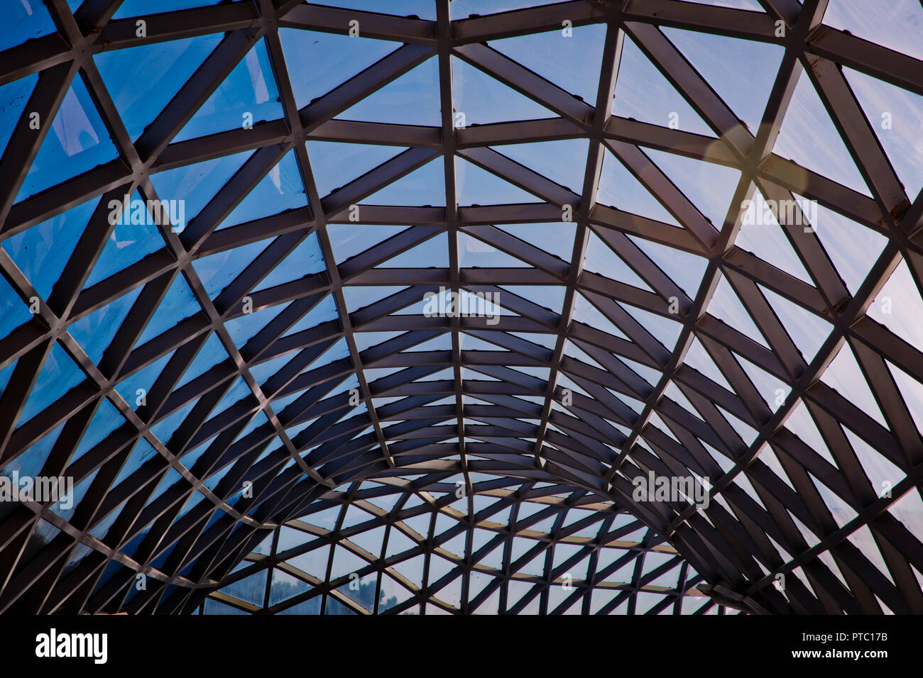 glass roof of a modern building and blue sky . Triangle aluminum alloy ...