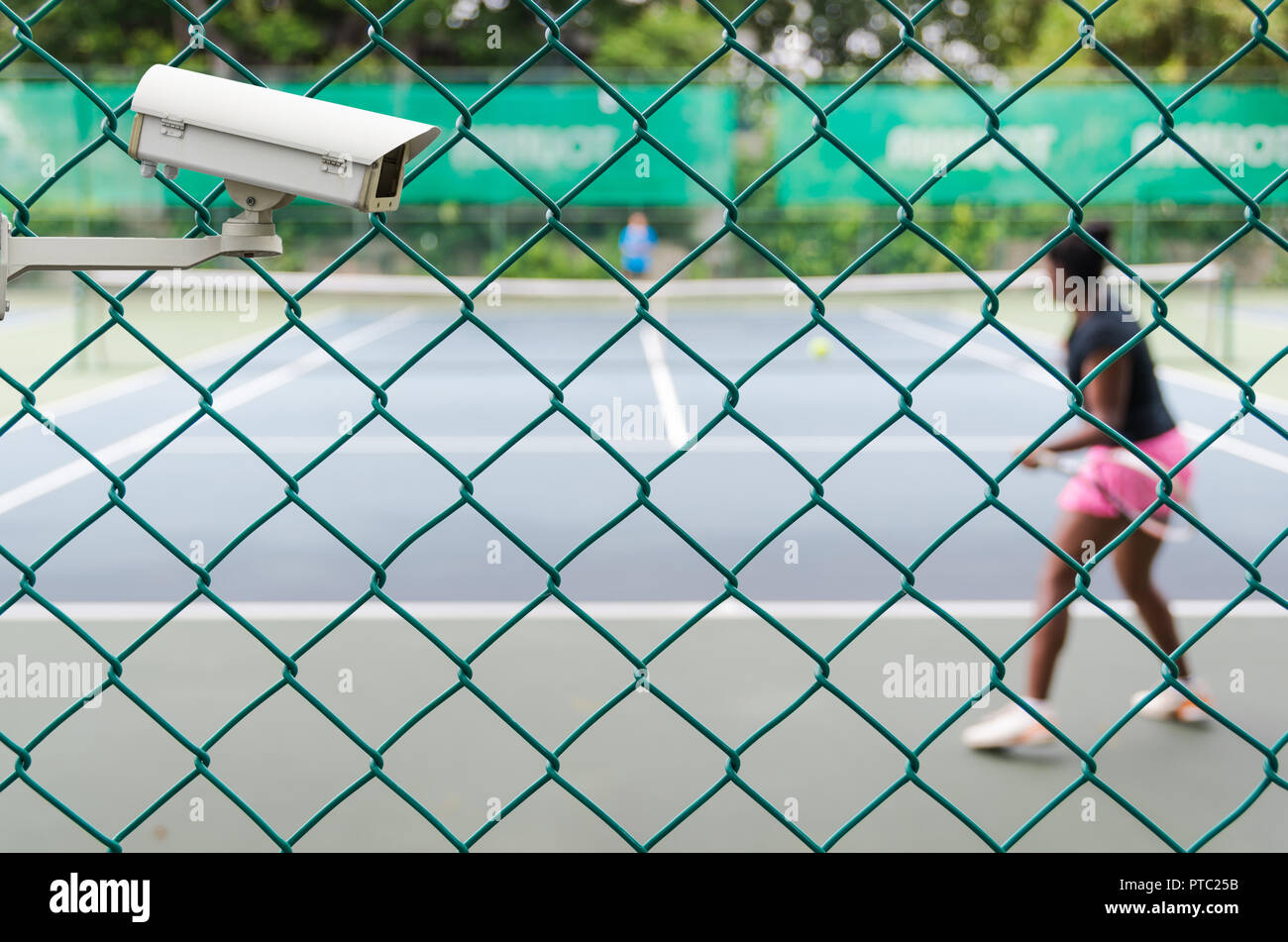 CCTV security camera on the Defocus and blur photo of tennis court with ...
