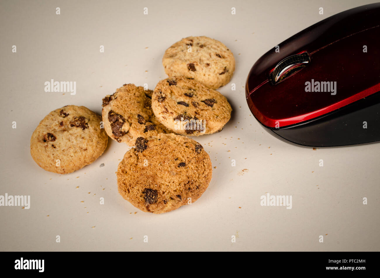 Mouse eating cookies, a funny technology concept Stock Photo - Alamy
