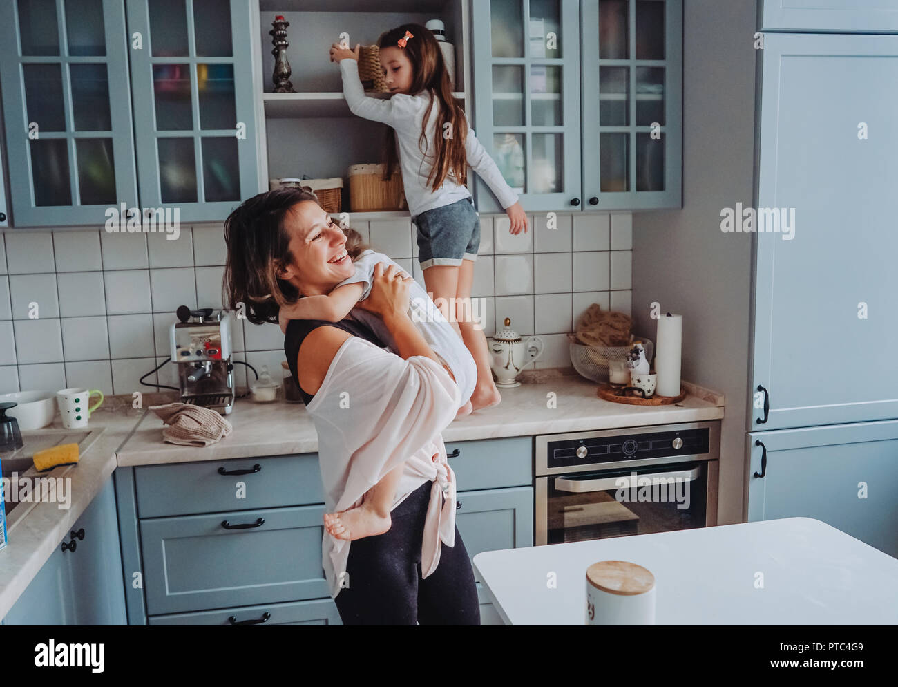 Happy family having fun in the kitchen Stock Photo - Alamy