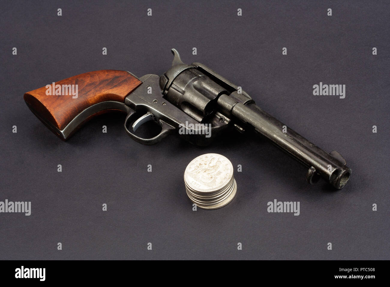 wild west revolver - colt single action army with silver dollars on ...