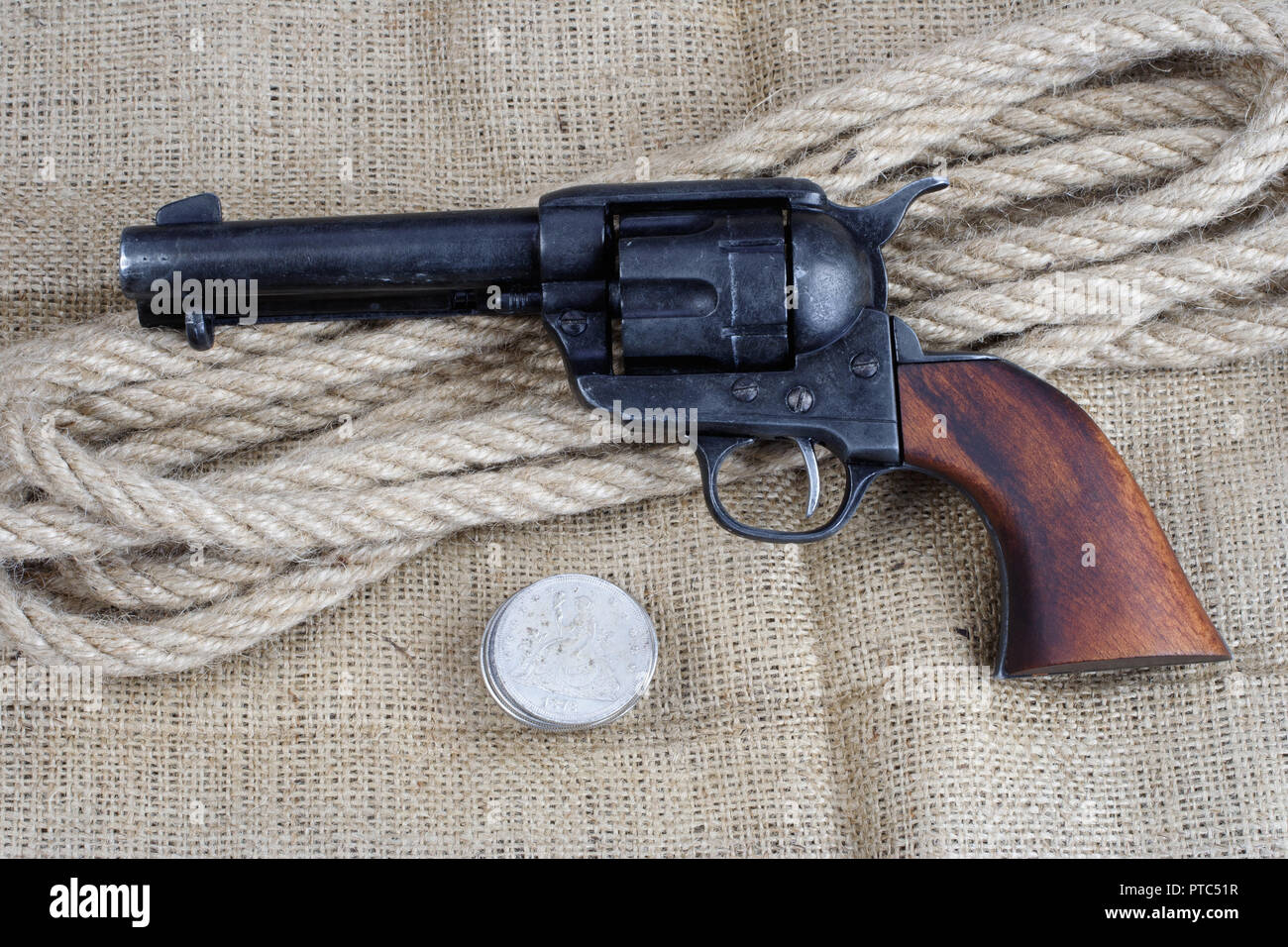 wild west revolver - colt single action army with silver dollars on ...