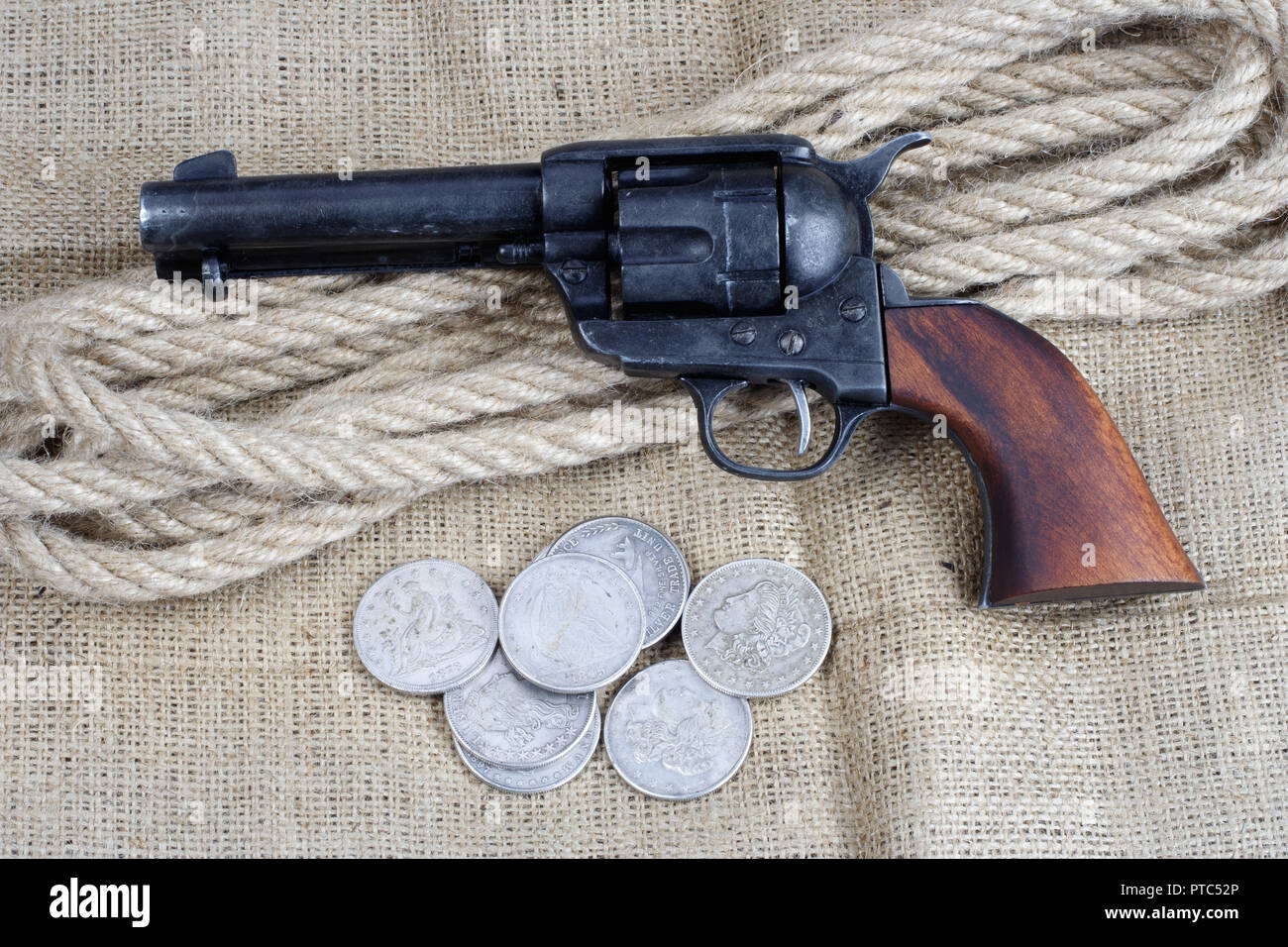 wild west revolver - colt single action army with silver dollars on ...