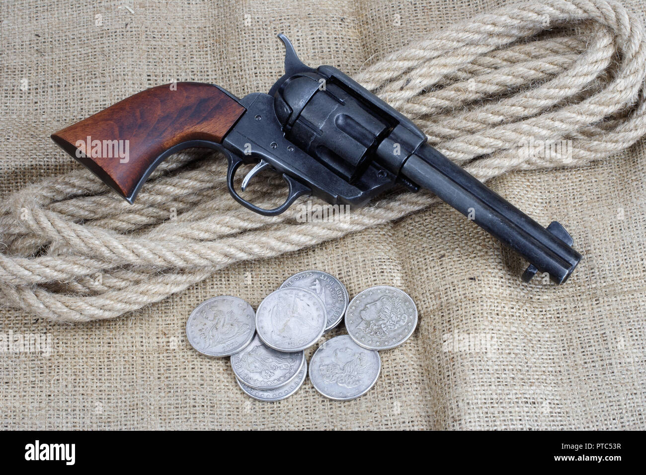wild west revolver - colt single action army with silver dollars on ...