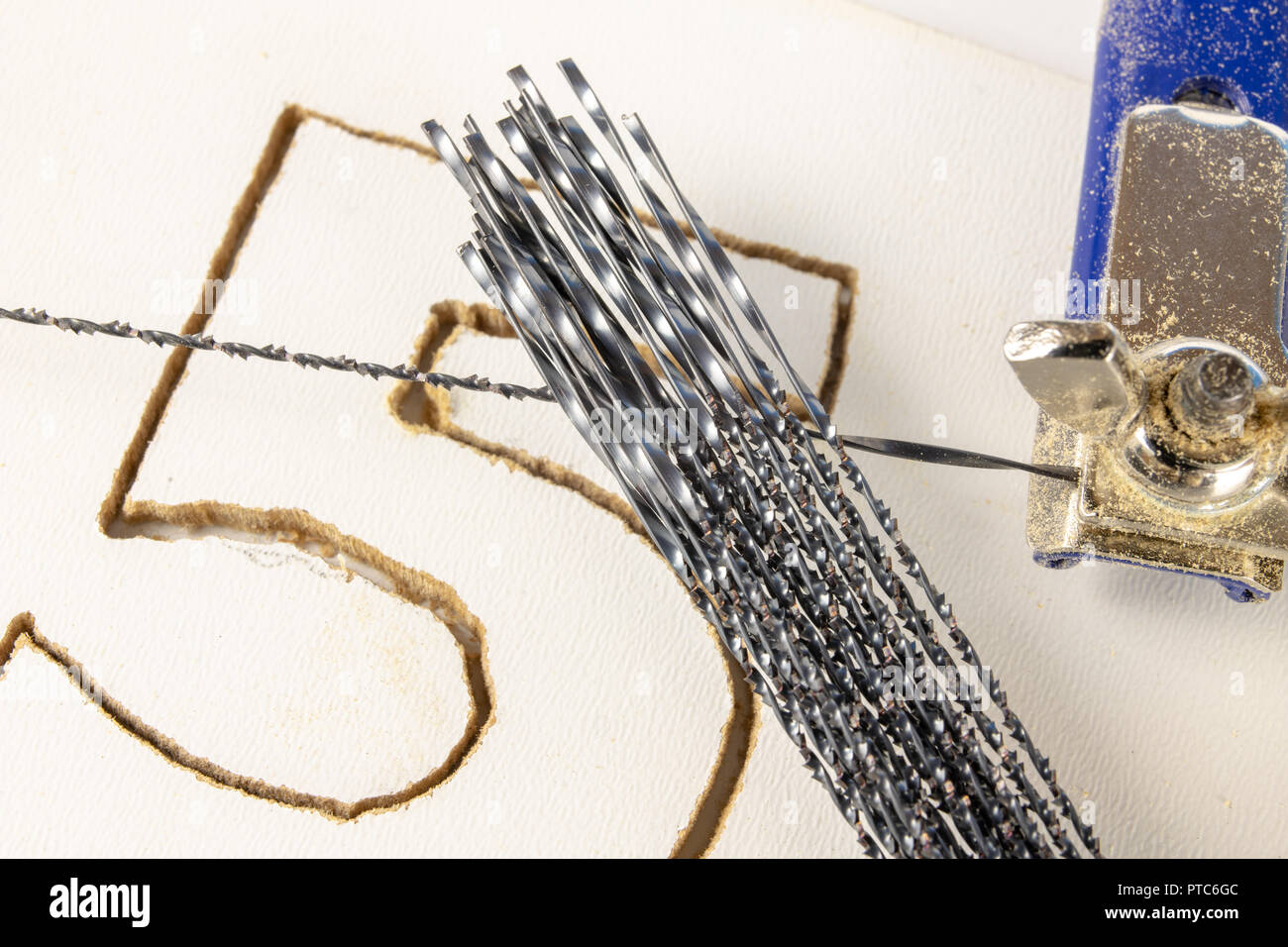 Precise saw for modelers and carpenters on the workshop table. Saw with ...