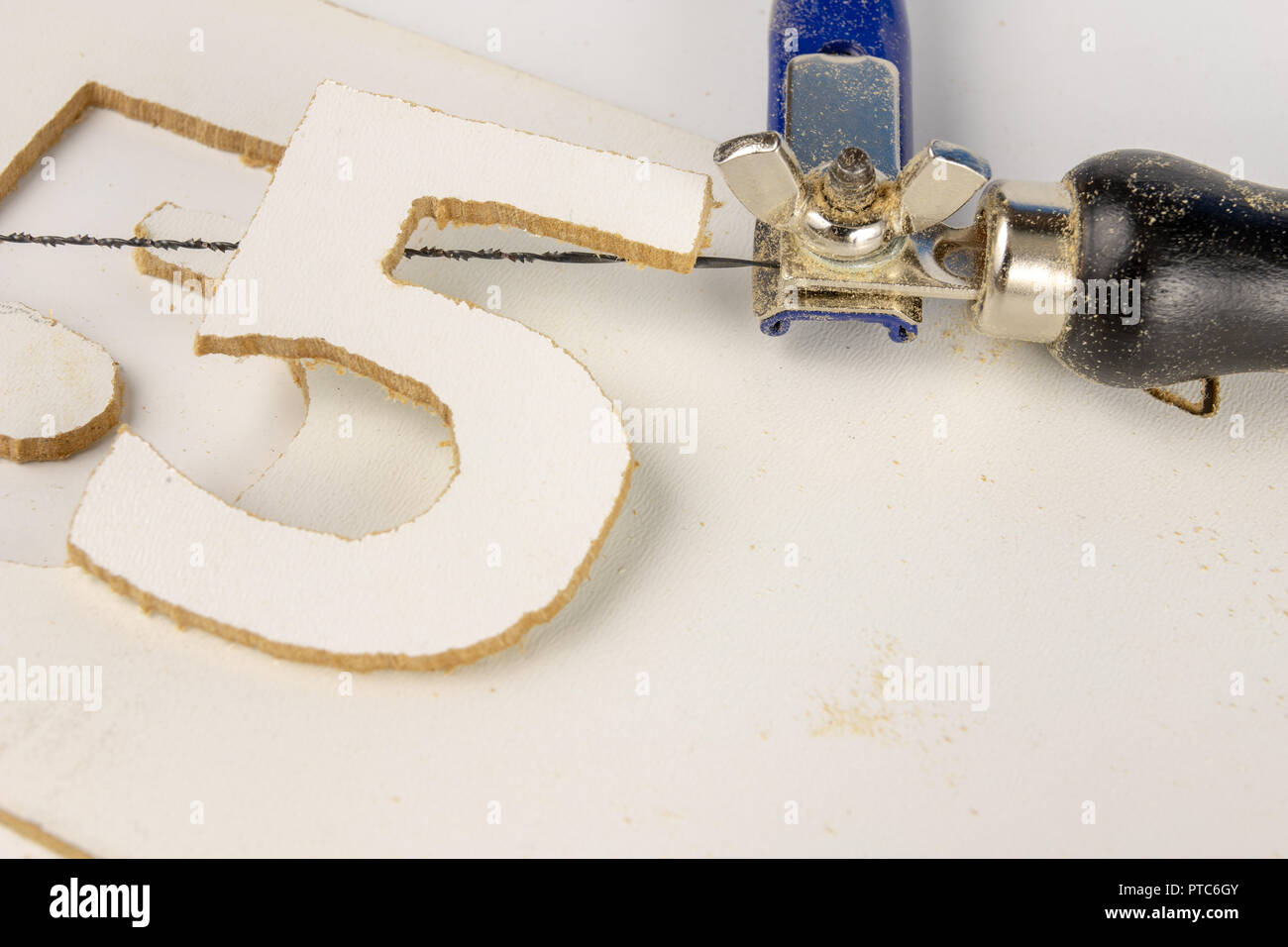 Precise saw for modelers and carpenters on the workshop table. Saw with ...