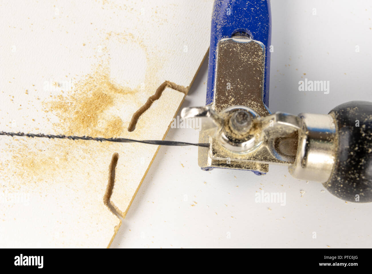 Precise saw for modelers and carpenters on the workshop table. Saw with ...