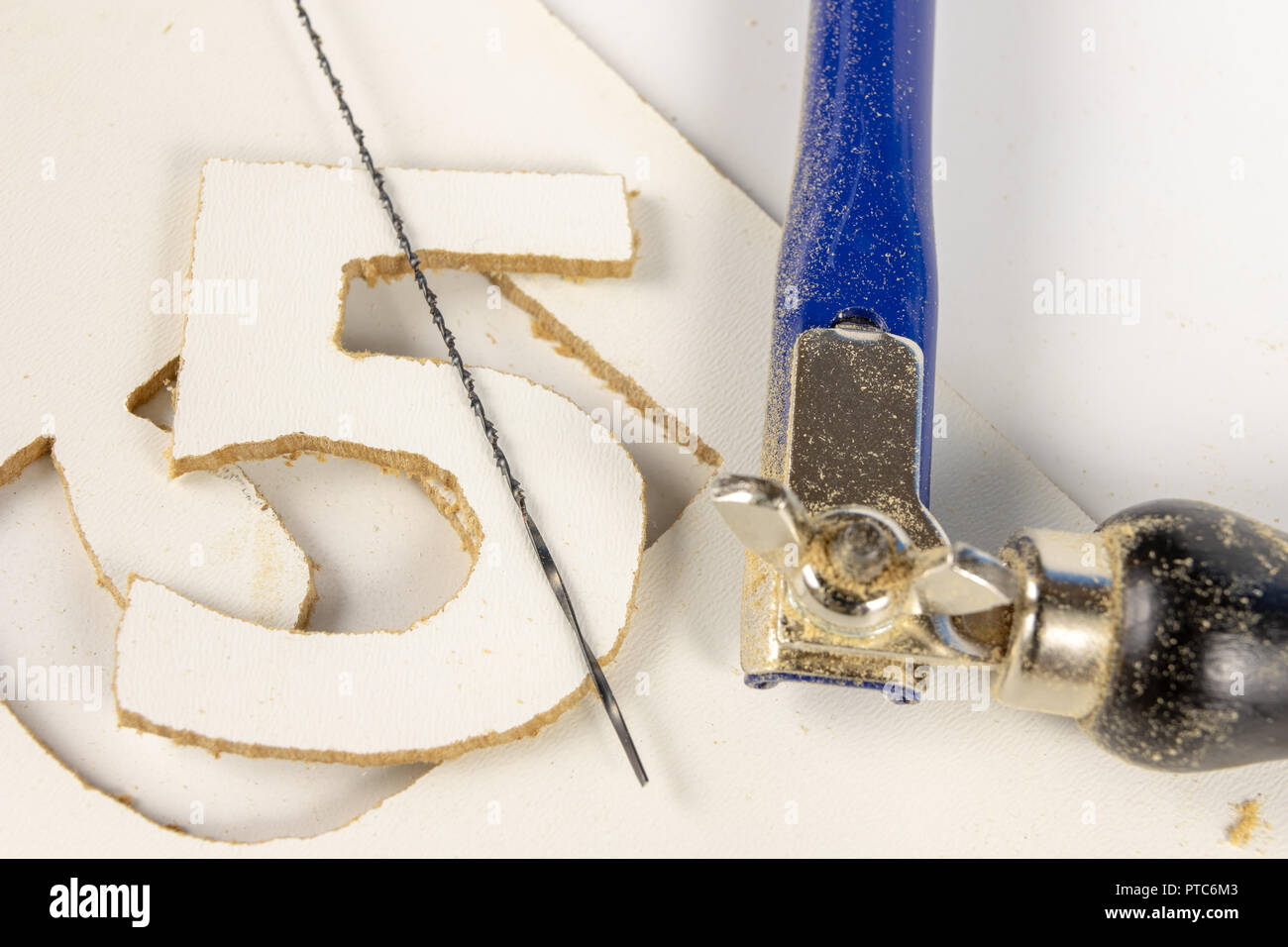 Precise saw for modelers and carpenters on the workshop table. Saw with ...