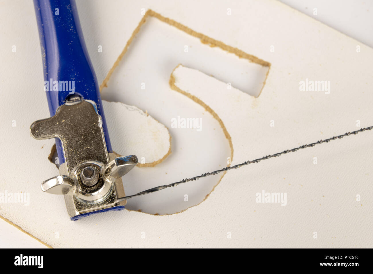 Precise saw for modelers and carpenters on the workshop table. Saw with ...