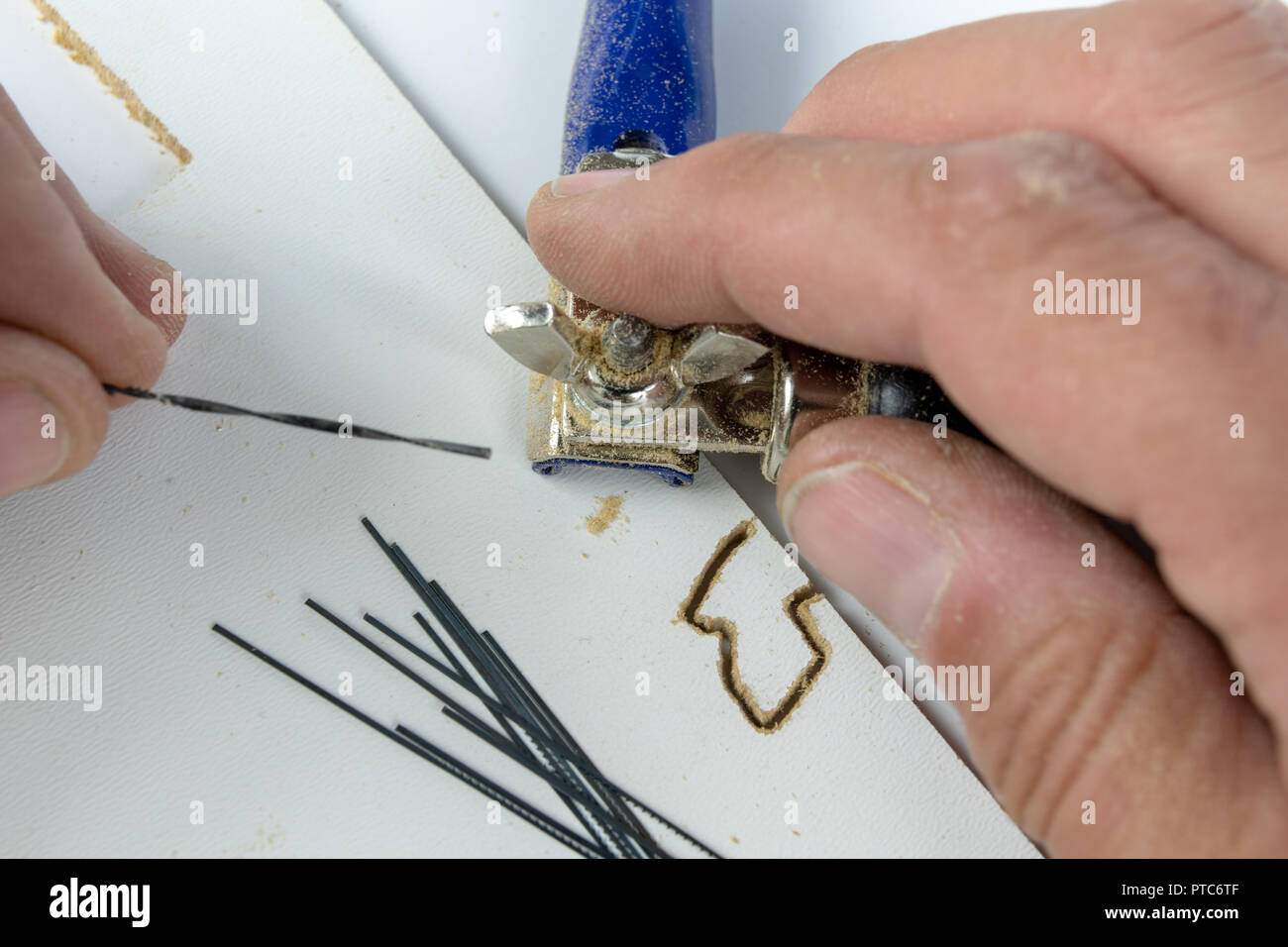 Precise saw for modelers and carpenters on the workshop table. Saw with ...