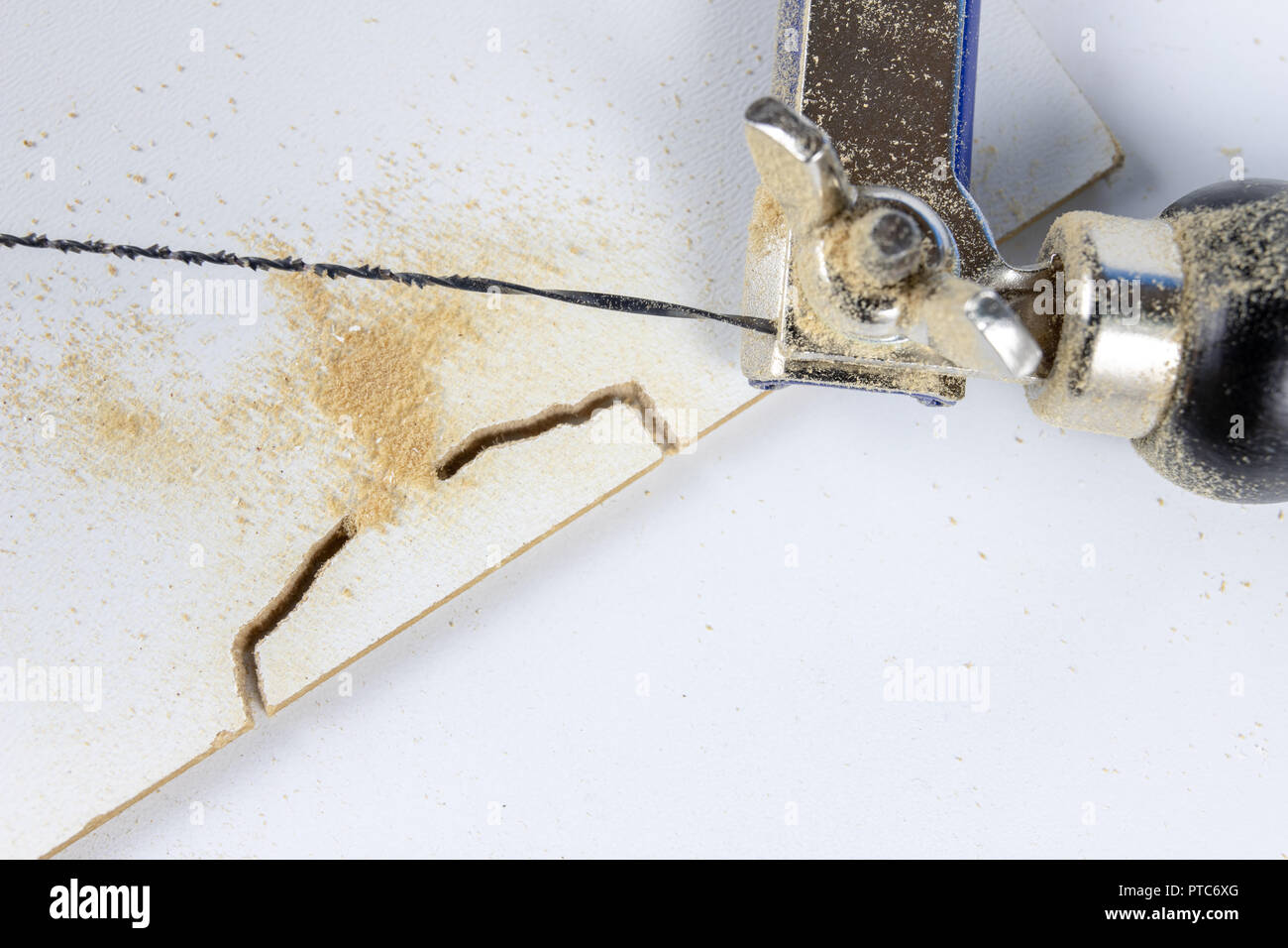 Precise saw for modelers and carpenters on the workshop table. Saw with ...