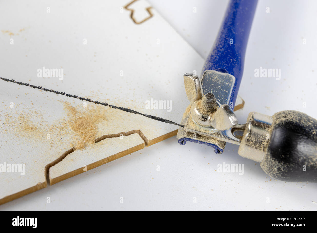 Precise saw for modelers and carpenters on the workshop table. Saw with ...