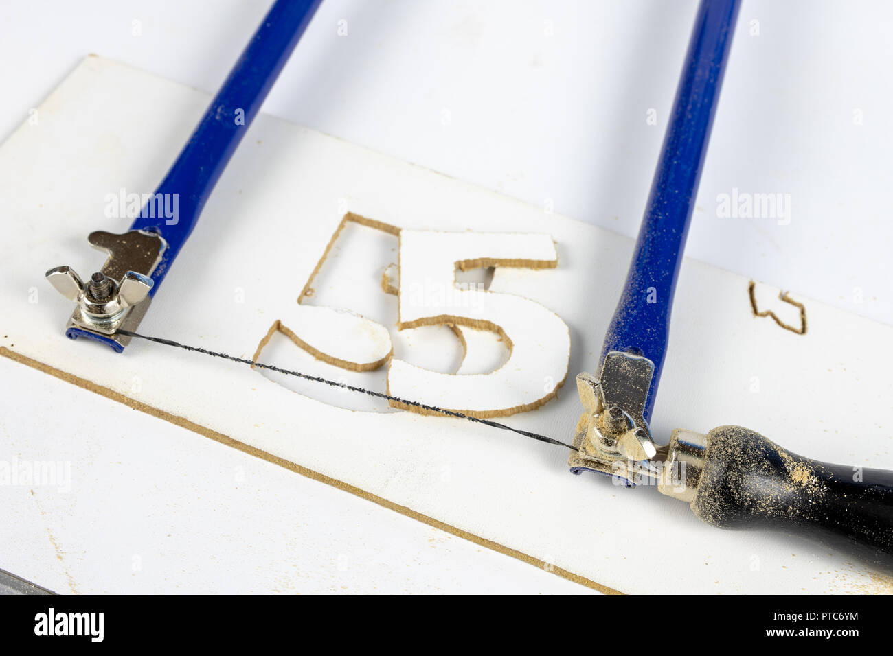 Precise saw for modelers and carpenters on the workshop table. Saw with ...