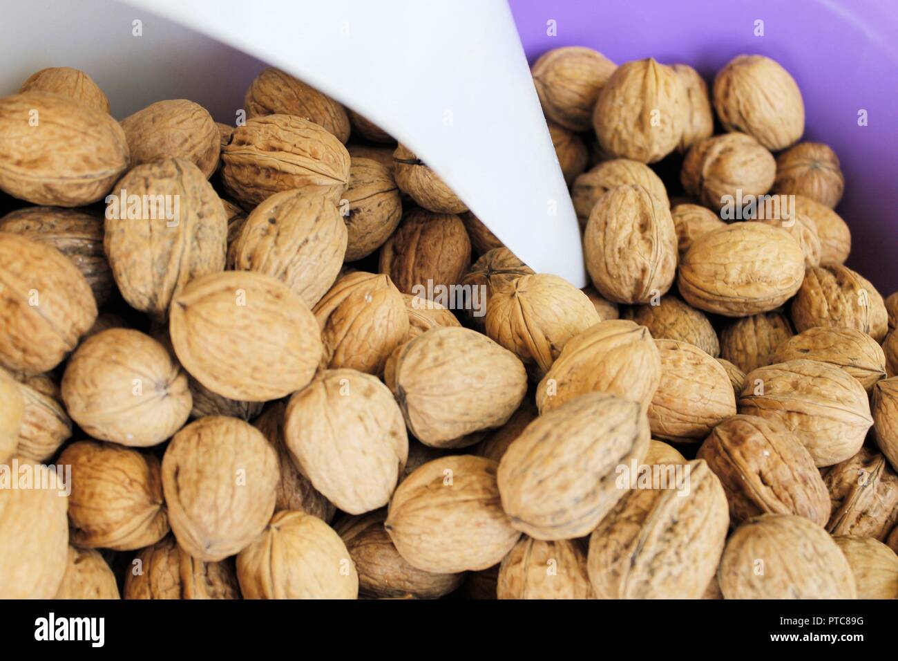 Crude walnut with nutshell for background of texture Stock Photo - Alamy