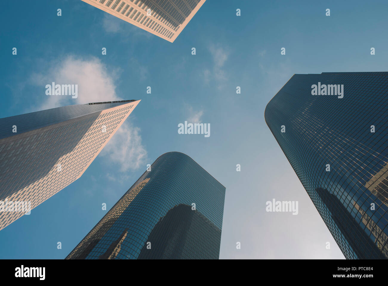 A group of four sky scrapers seen reaching to the blue sky Stock Photo ...