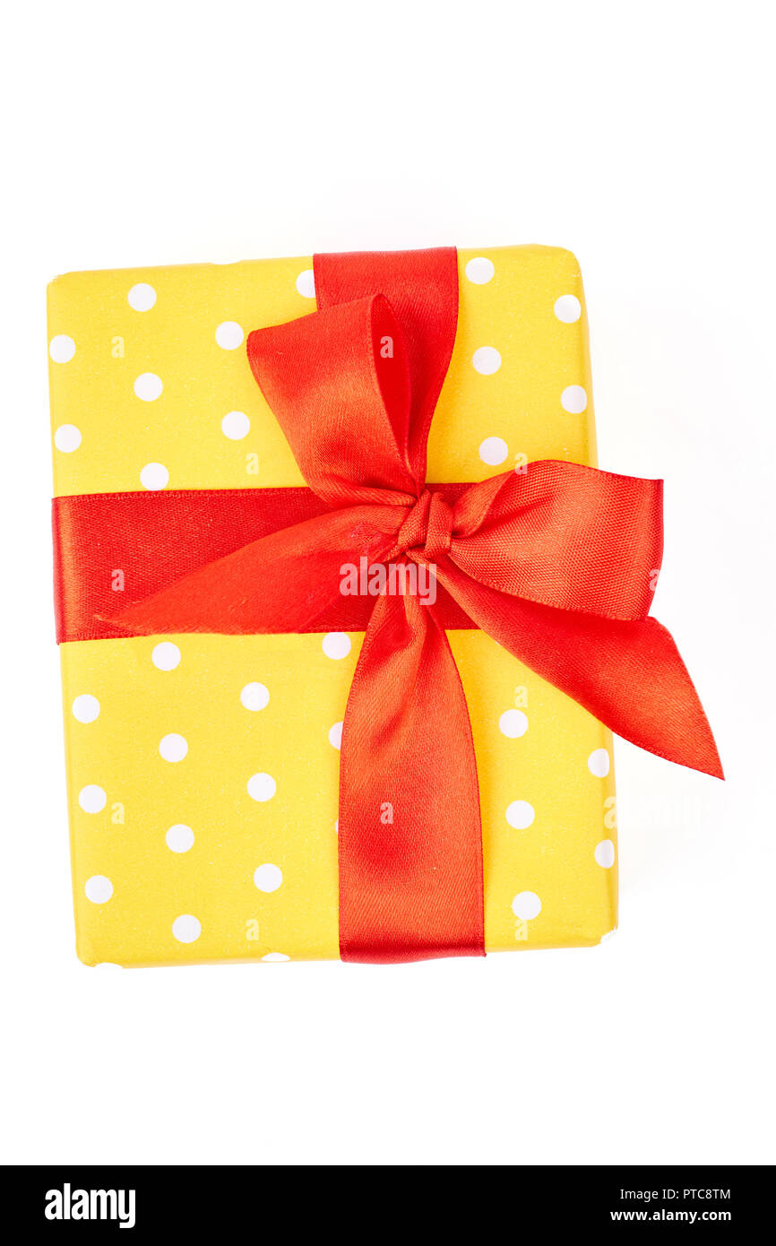 Yellow gift box with red bow. Box with present wrapped in yellow dotted ...