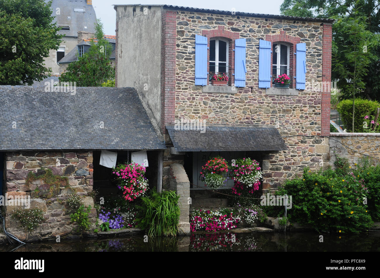 Floral displays by traditional riverside wash houses, Pontrieux ...