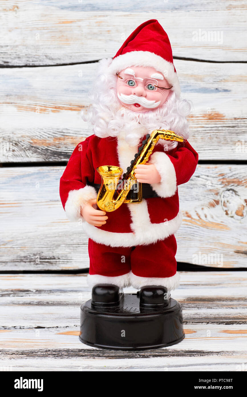 Santa Claus doll with saxophone. Musical toy Santa Claus with golden ...