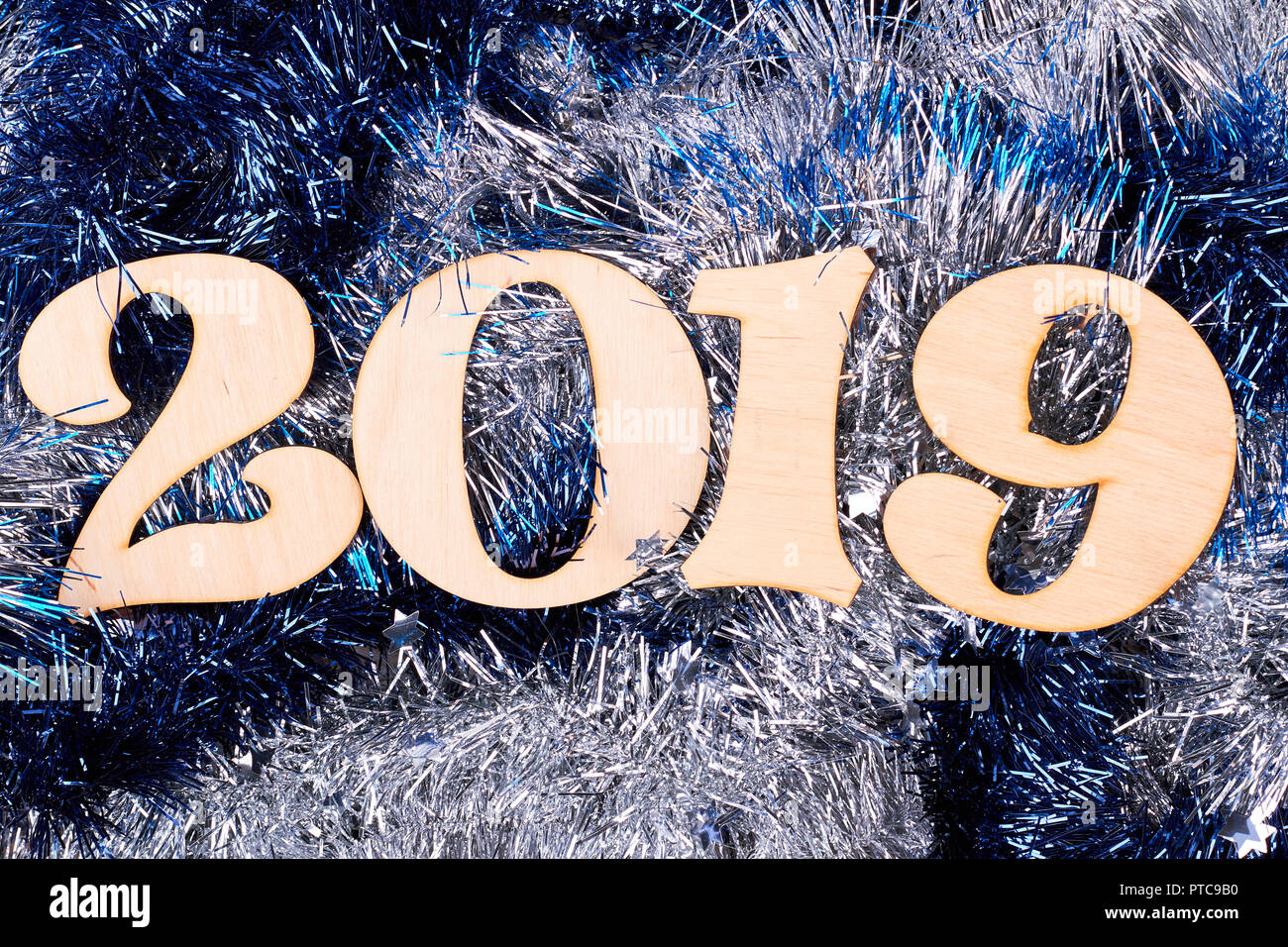 Wooden number 2019 on shiny tinsel background. Wooden carved numbers ...