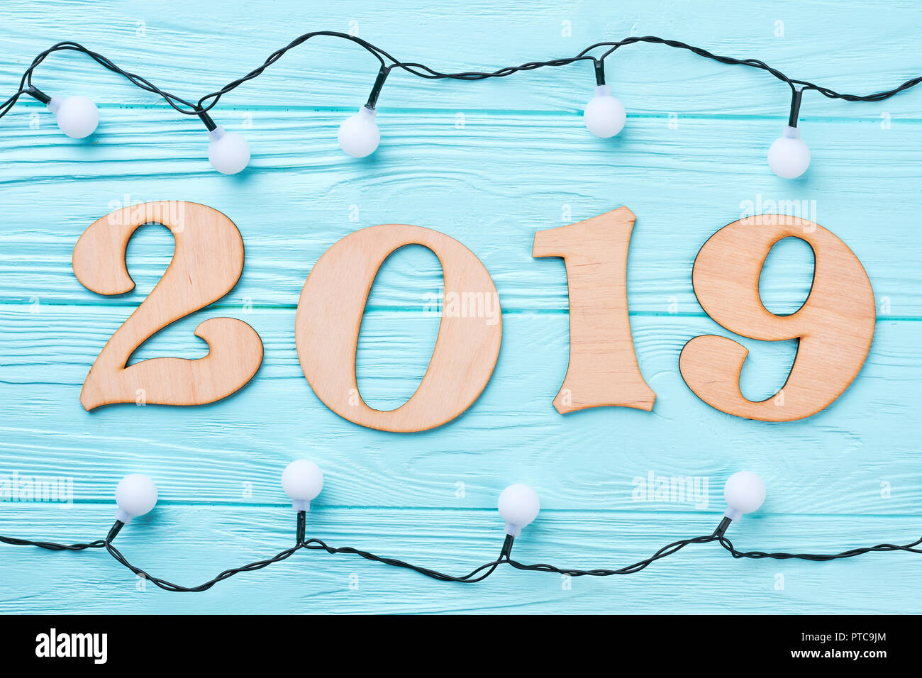 Cut out wooden number 2019 and Christmas lights. Carved wooden digit ...