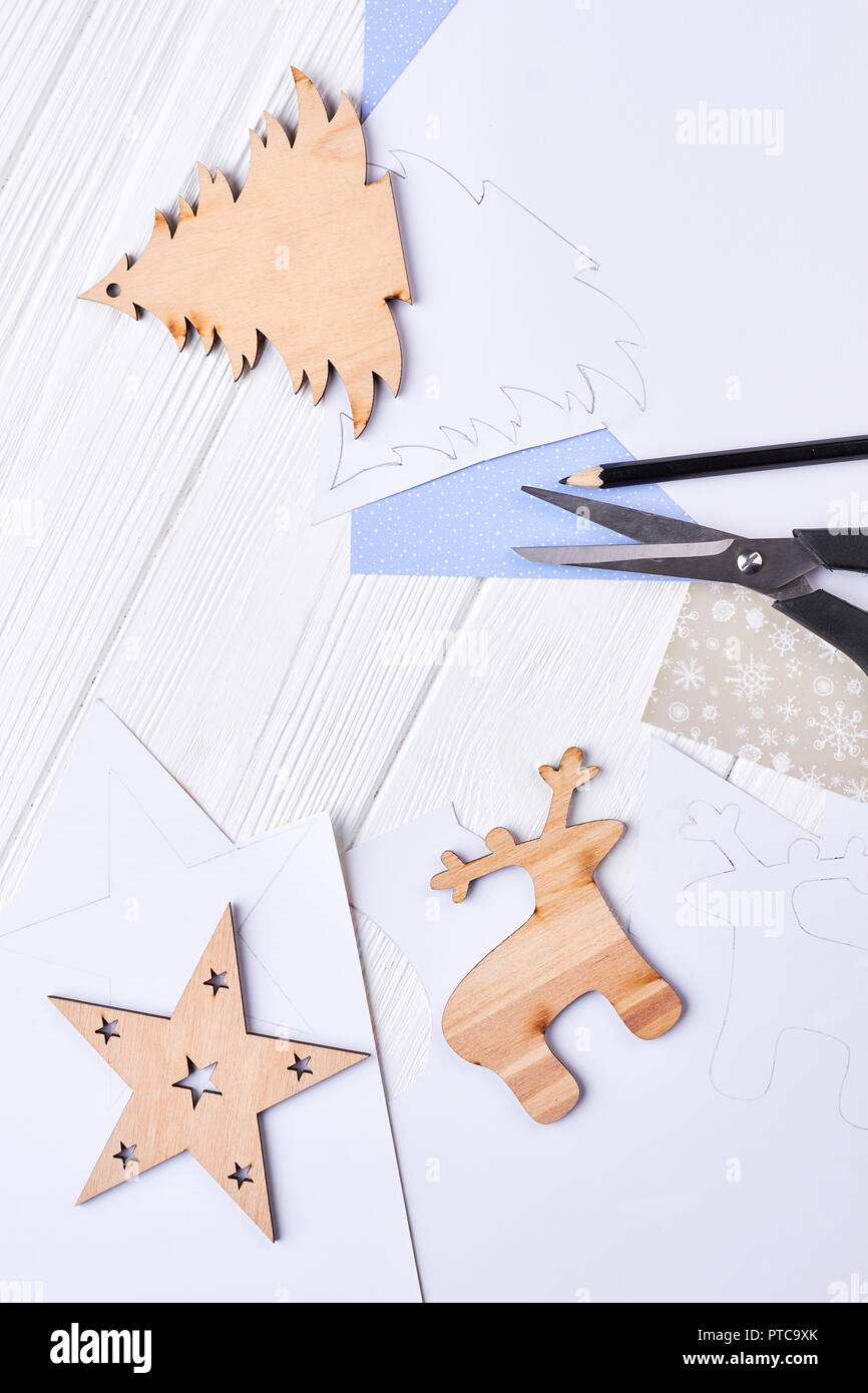 Wooden Christmas ornaments, paper, scissors. Cut out wooden Christmas ...