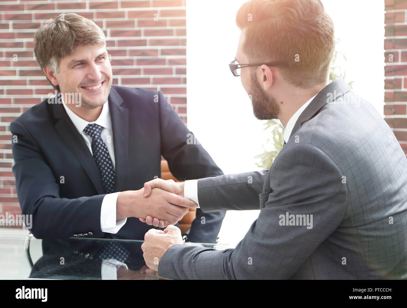 greeting handshake of colleagues at the desk Stock Photo - Alamy