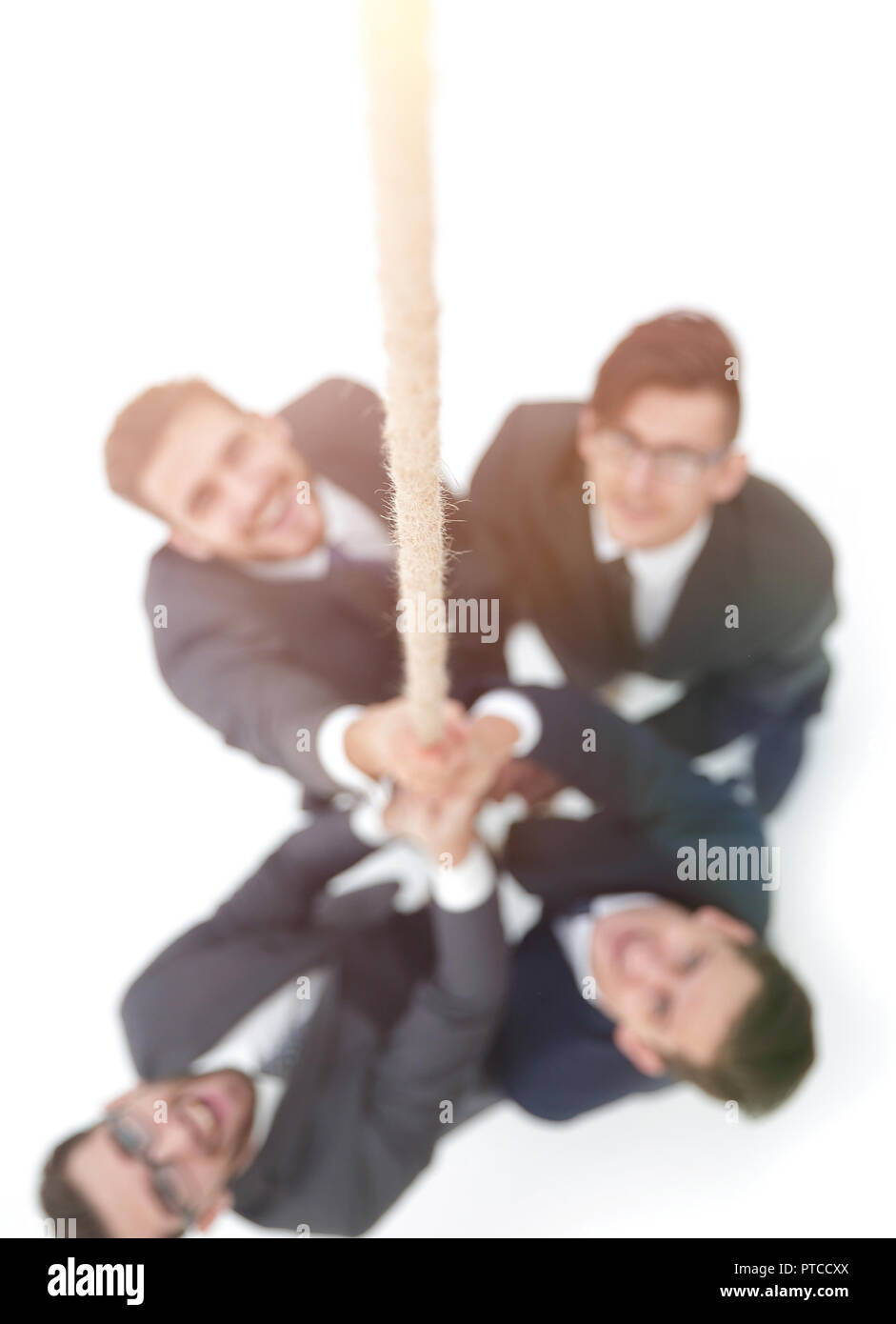smiling business team holding the rope Stock Photo - Alamy
