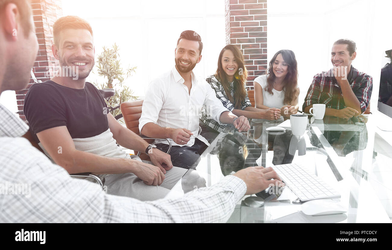 business team sitting at a modern Desk Stock Photo - Alamy