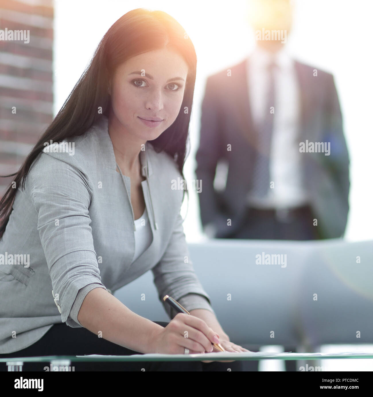 business woman signs documents in a modern office Stock Photo - Alamy