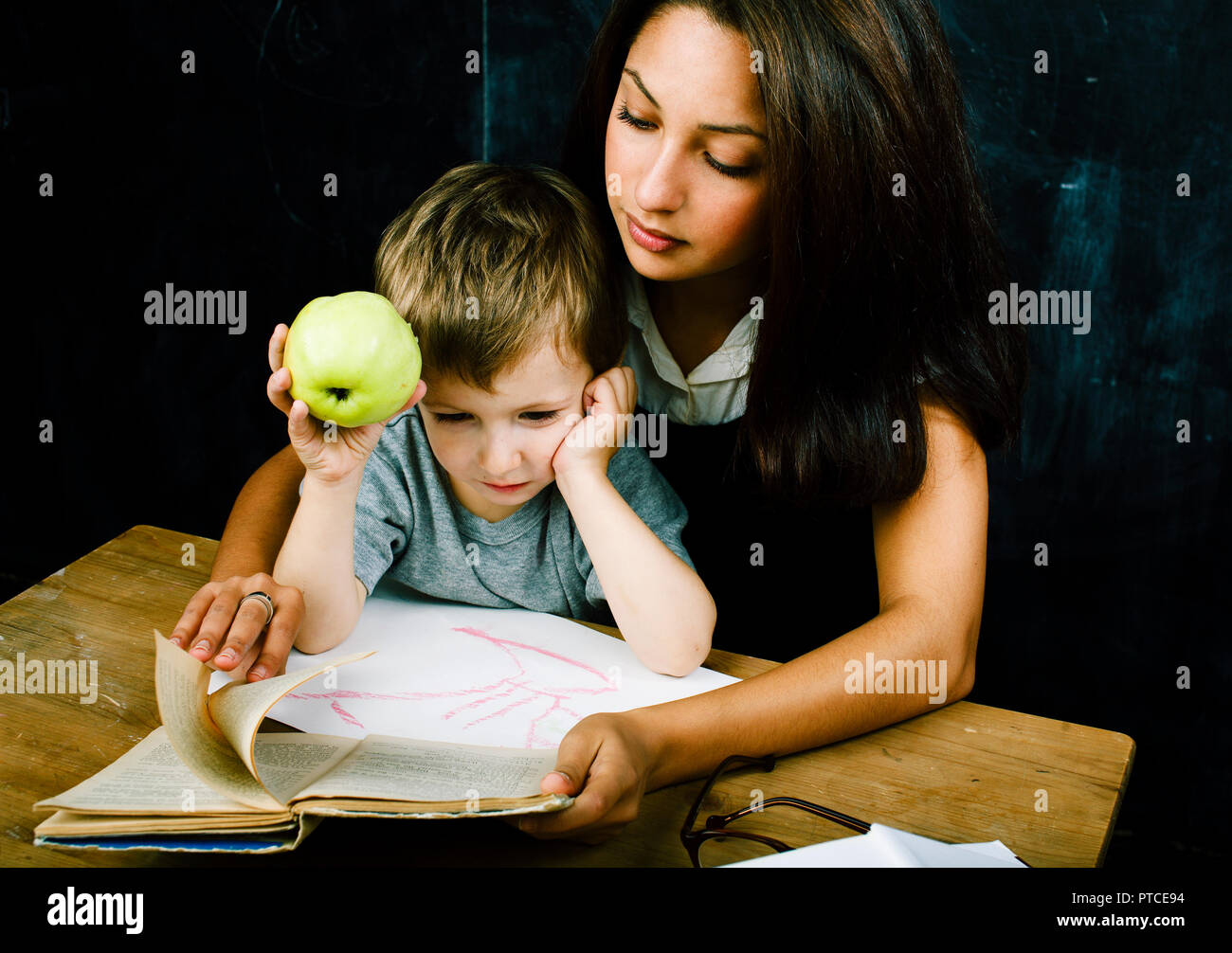 little cute boy pupil with young real teacher, classroom studyin Stock ...