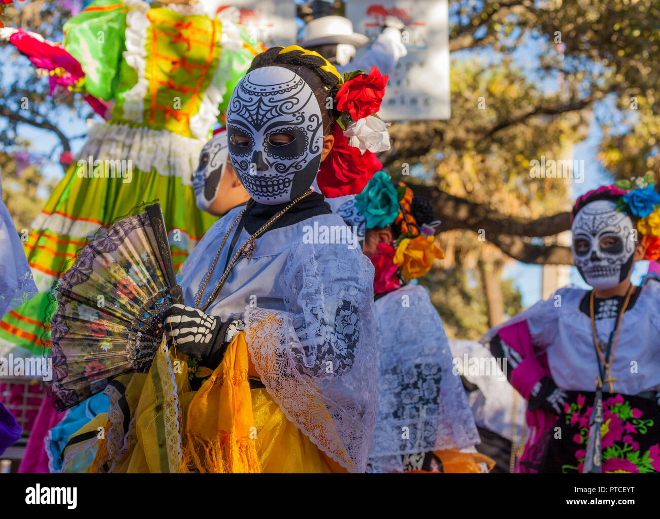 Group of unrecognizable women wearing traditional sugar skull masks and ...