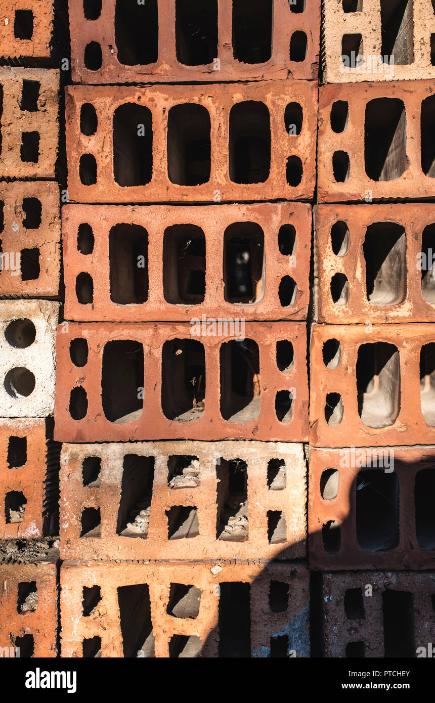 Stacked bricks background. Sunlight Stock Photo - Alamy