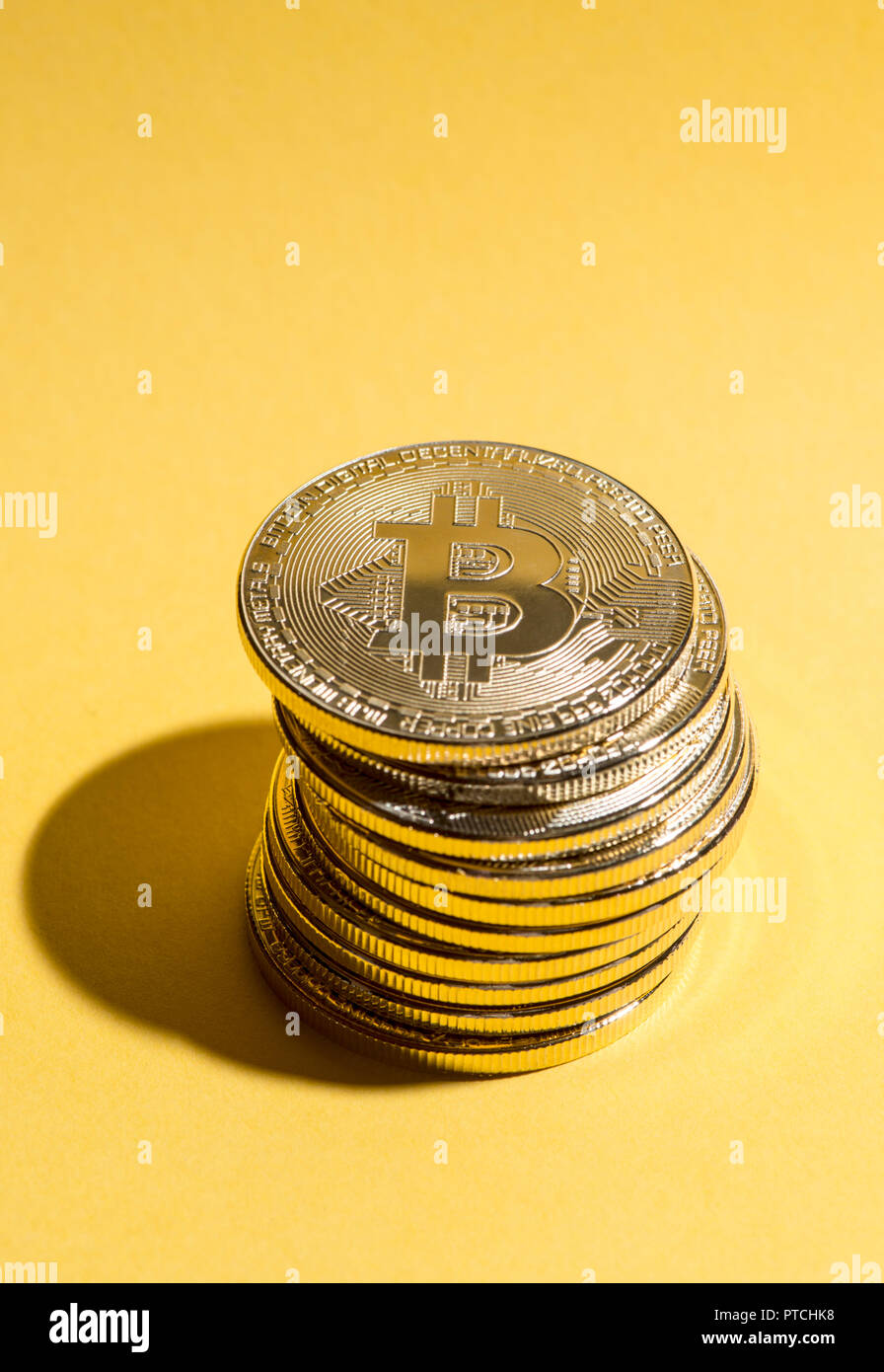 Bitcoin stack on yellow background Stock Photo - Alamy
