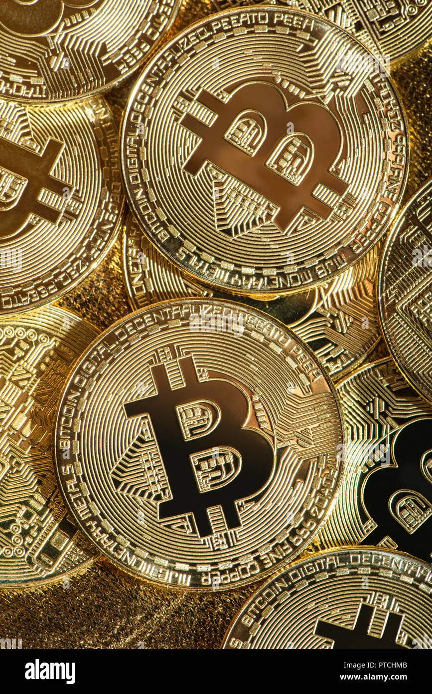 Many Bitcoin coins on gold background Stock Photo - Alamy