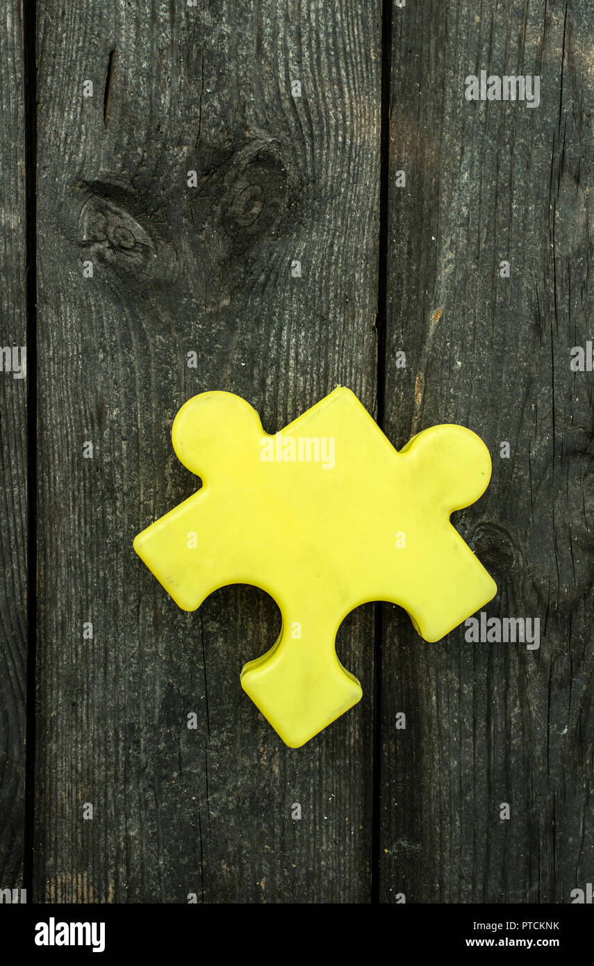 Yellow Puzzle piece in the garden Stock Photo - Alamy