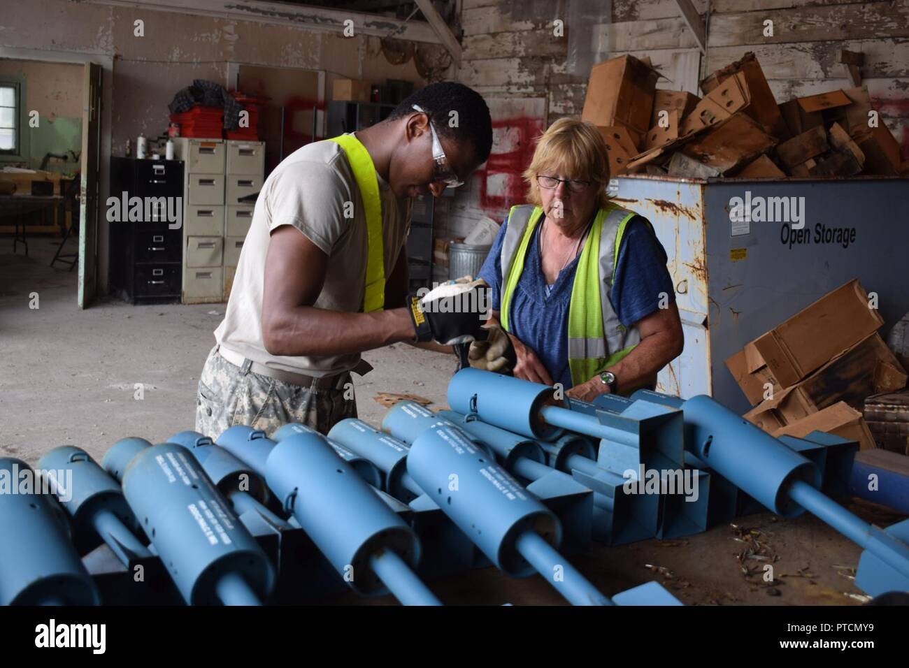 A soldier from the 221st Ordnance company consults with a Crane Army ...