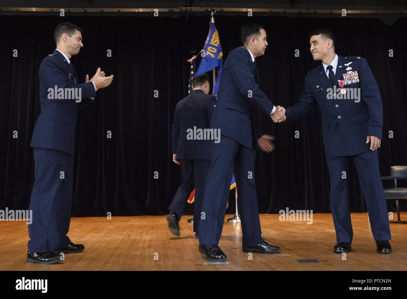 Col. Ricky Mills, (right) congratulates the new commander of the 707th ...