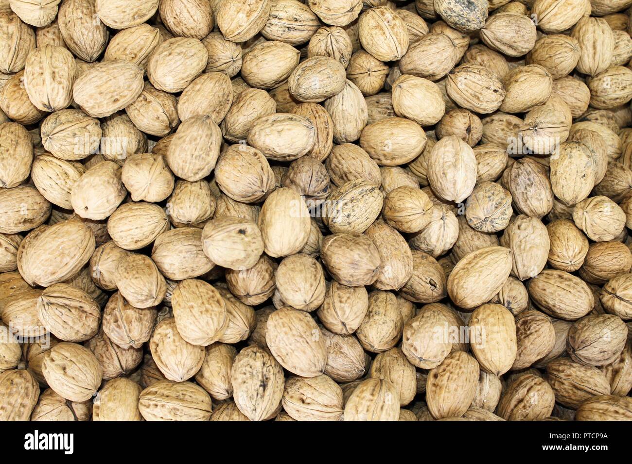 Crude walnut with nutshell for background of texture Stock Photo - Alamy
