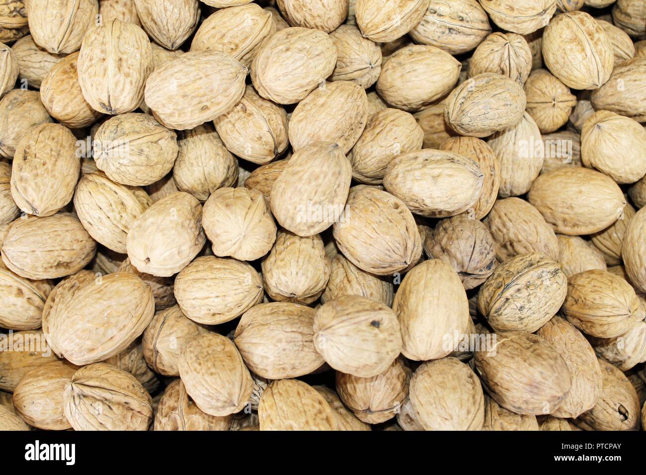 Crude walnut with nutshell for background of texture Stock Photo - Alamy
